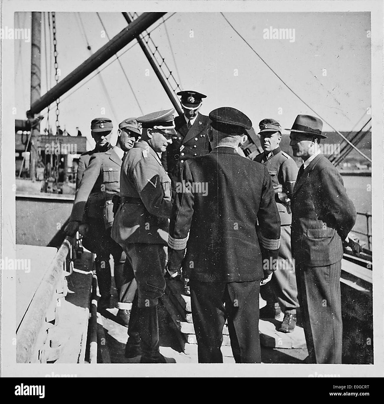 A photograph from World War II, featuring a report to the ...