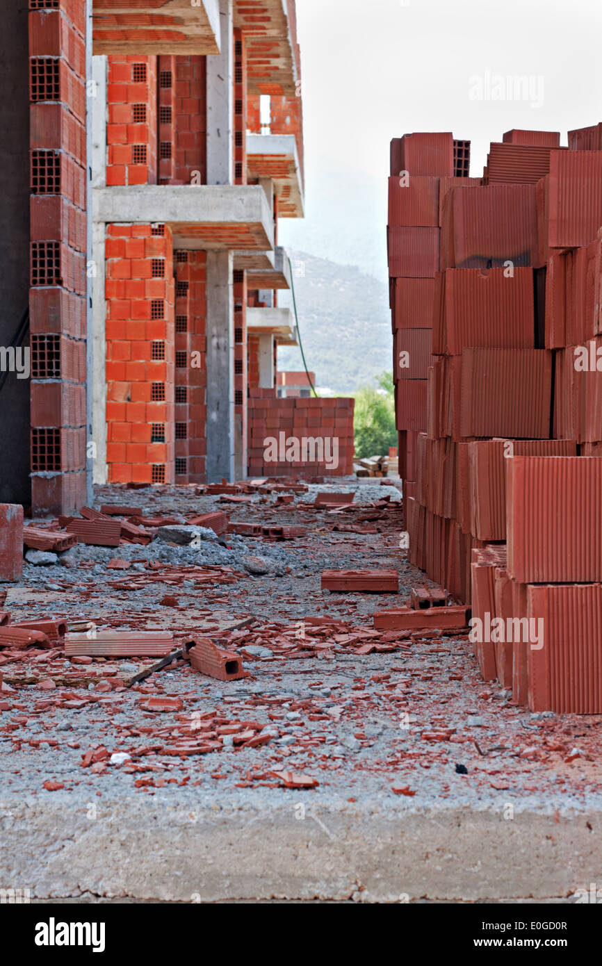 Stack of red building blocks on an untidy construction site Stock Photo ...