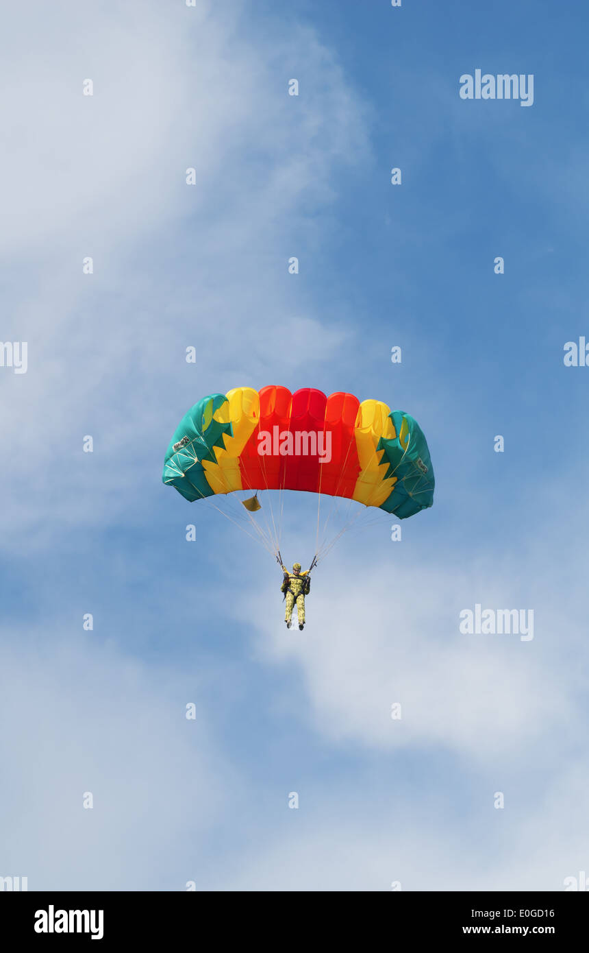 One day with parachutist in airfield. The skydiver landing under green ...