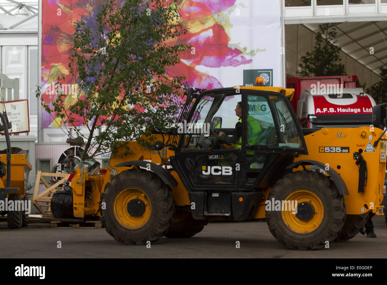 London UK. 13th May 2014. A forklift truck carries a large unplanted ...