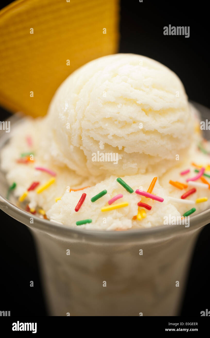 Vanilla ice cream cup with wafer over black background Stock Photo - Alamy