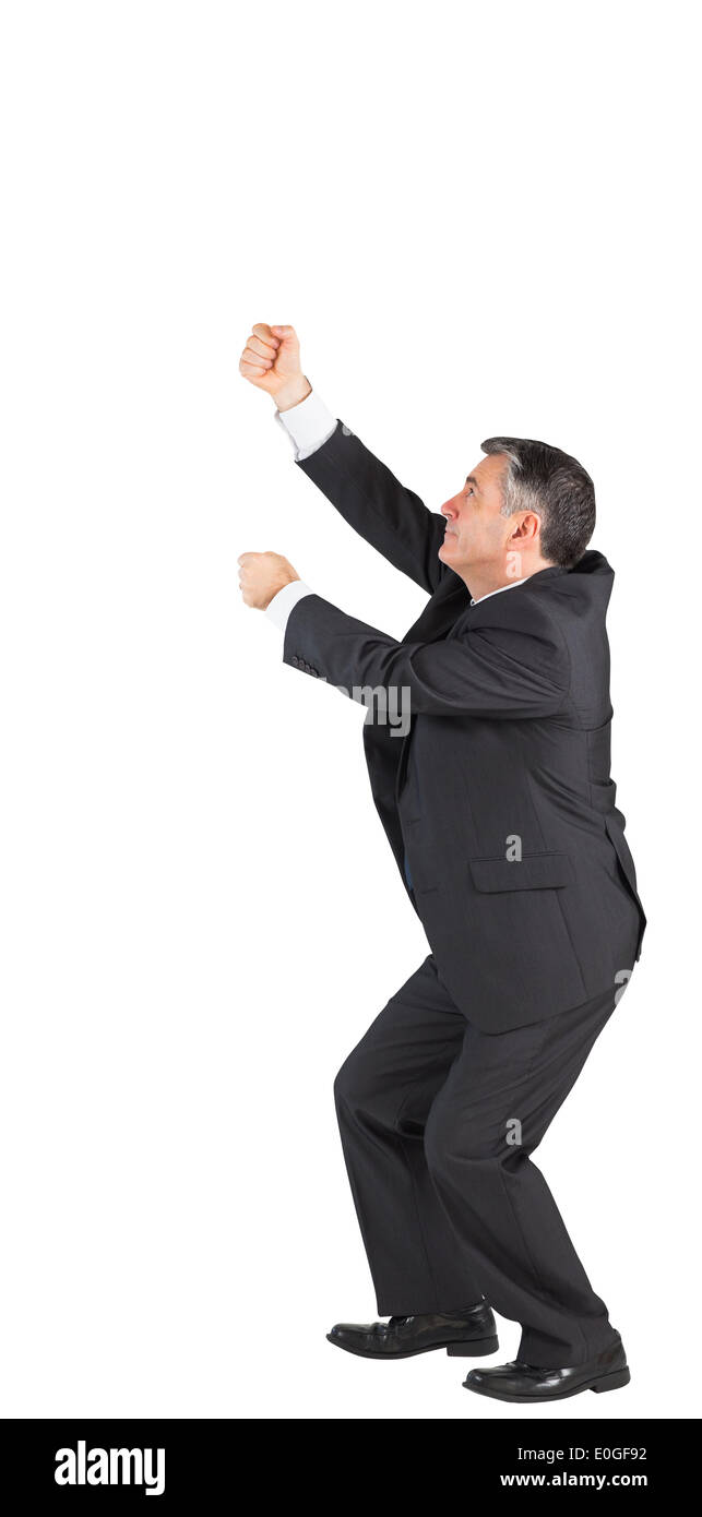 Mature businessman pulling with hands Stock Photo - Alamy