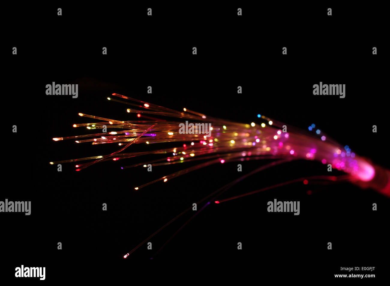 color fiber optic cables on black background Stock Photo - Alamy