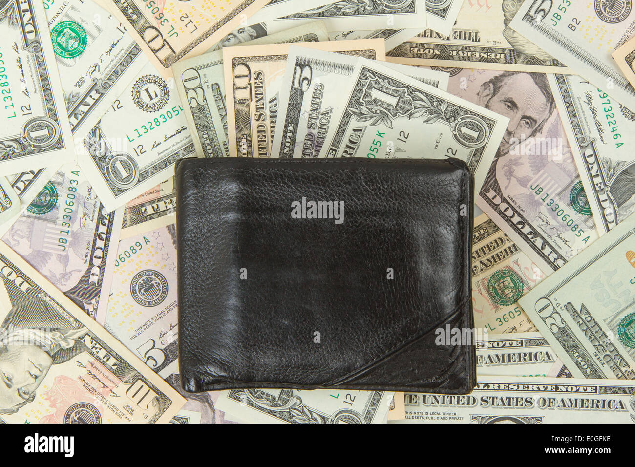 Old used wallet with dollars isolated on dollar bills Stock Photo - Alamy