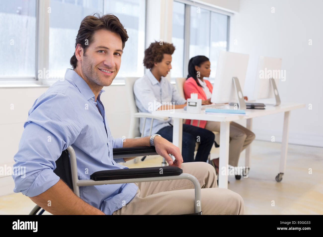 Businessman in wheelchair with disability at work Stock Photo - Alamy