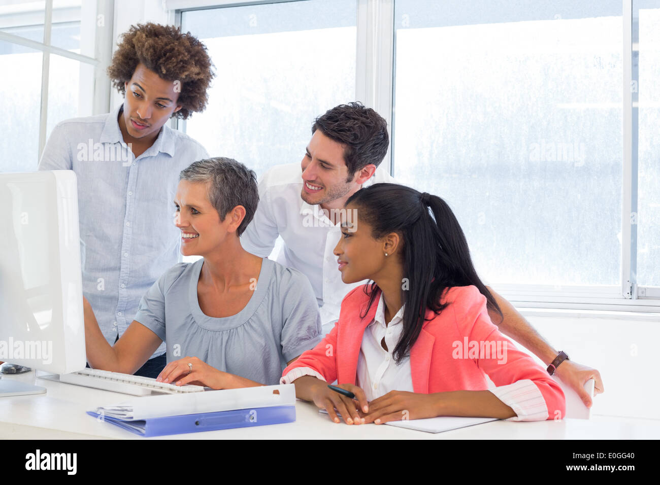 Worker showing colleagues her progress Stock Photo - Alamy