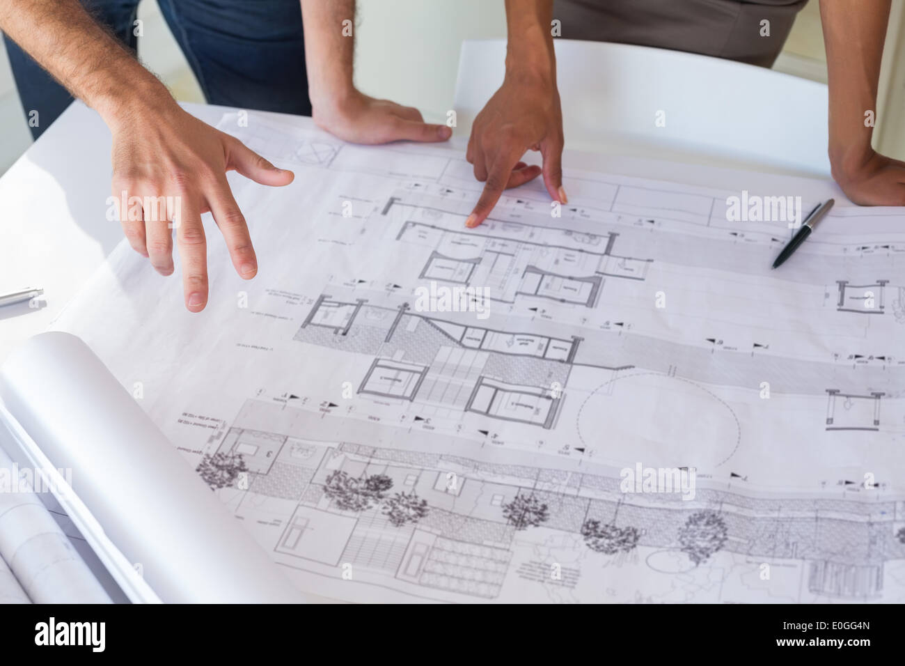 Workers looking at important blueprints Stock Photo - Alamy