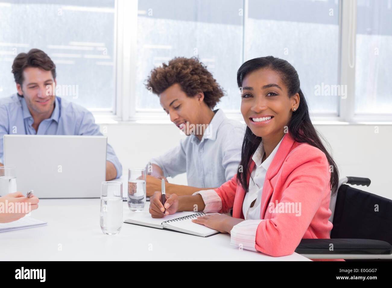 Attractive businesswoman smiling in the workplace Stock Photo - Alamy