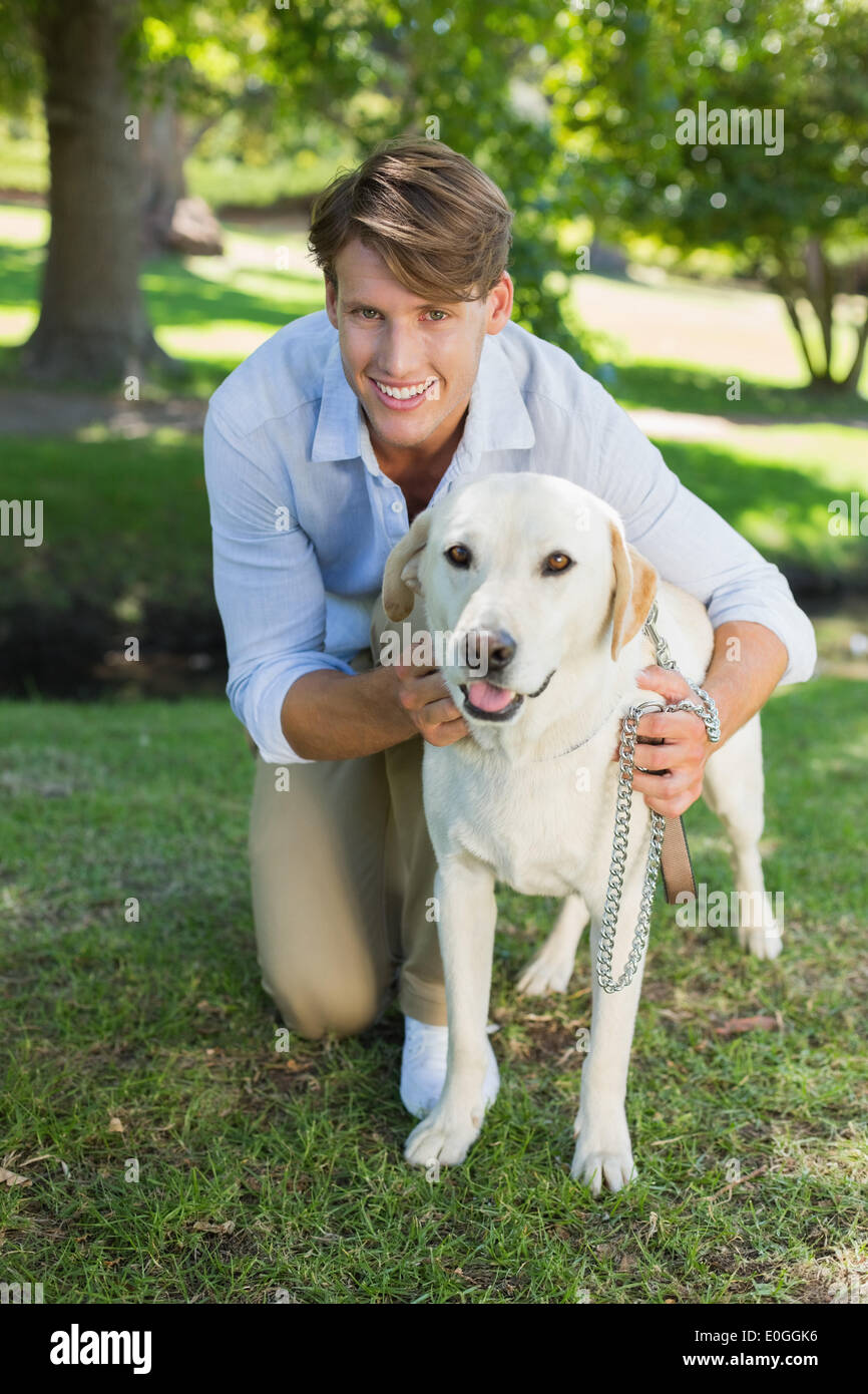 Handsome smiling man posing with his labrador in the park Stock Photo ...