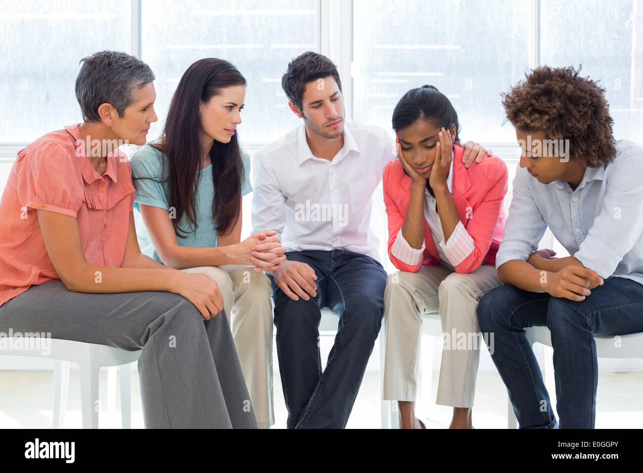 Group therapy in session sitting in a circle Stock Photo - Alamy