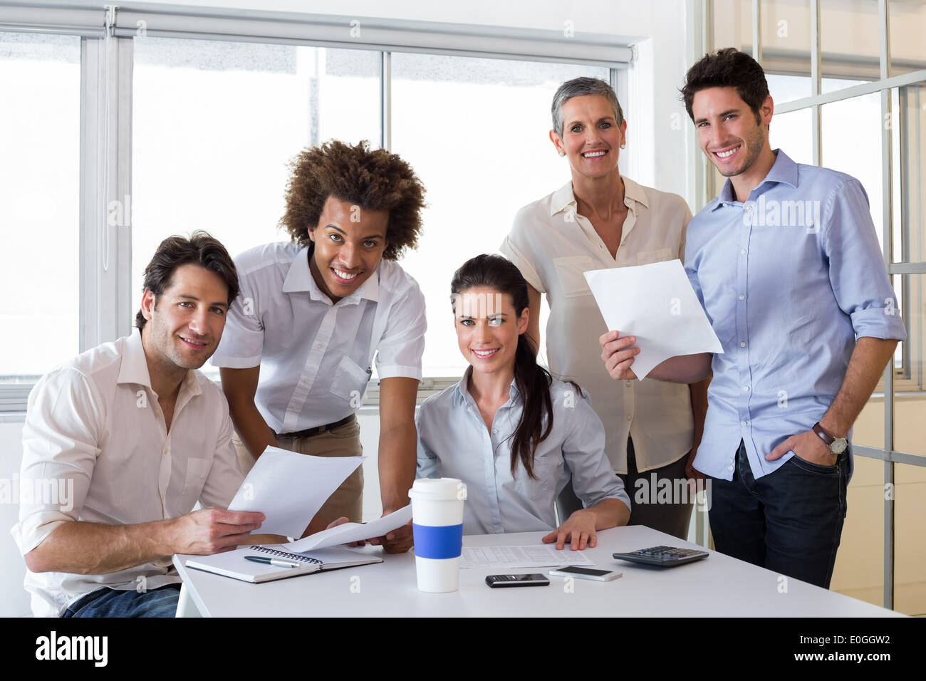 Attractive business people smiling in the workplace Stock Photo - Alamy