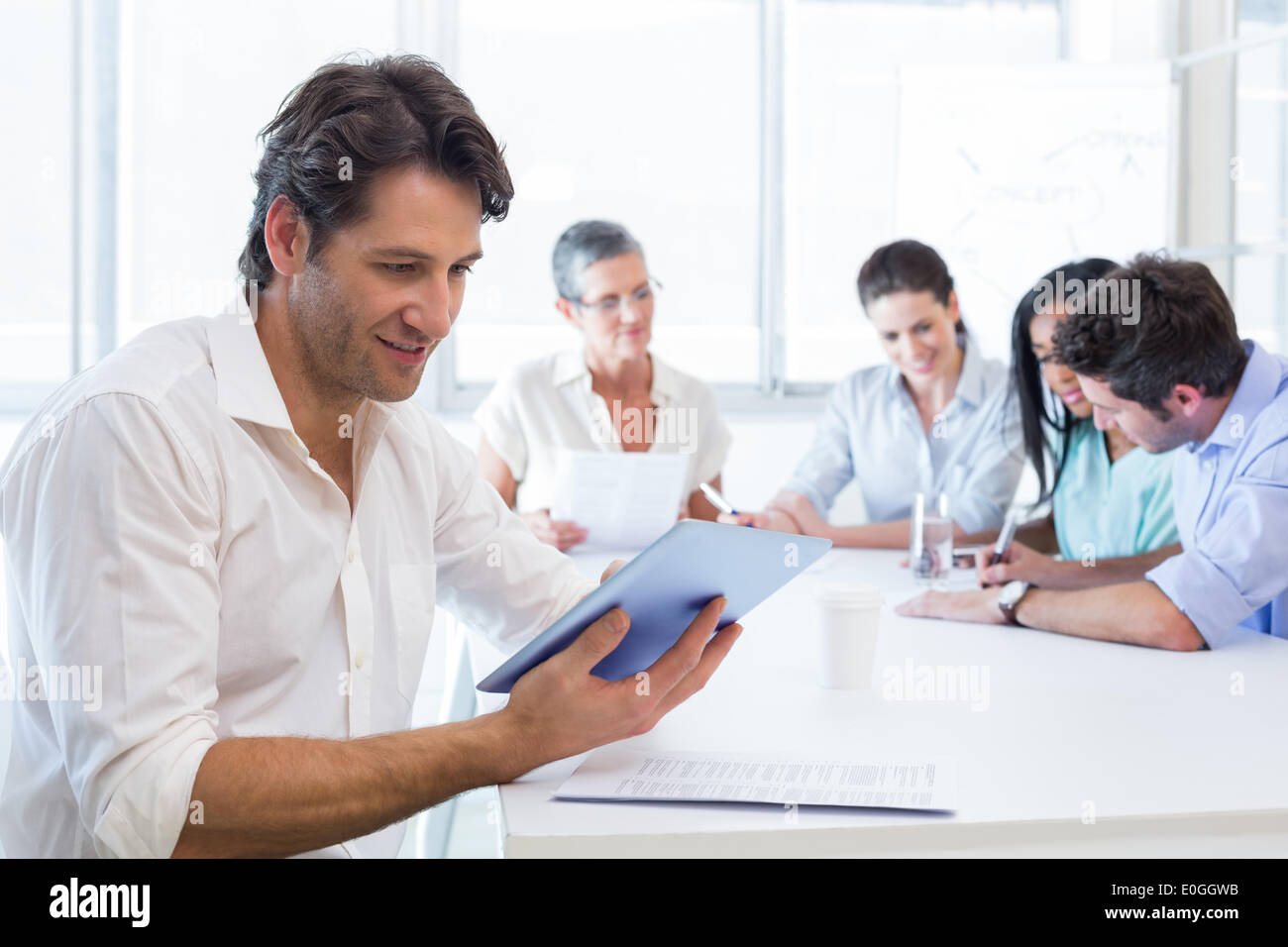 Attractive businessman using tablet hi-res stock photography and images ...