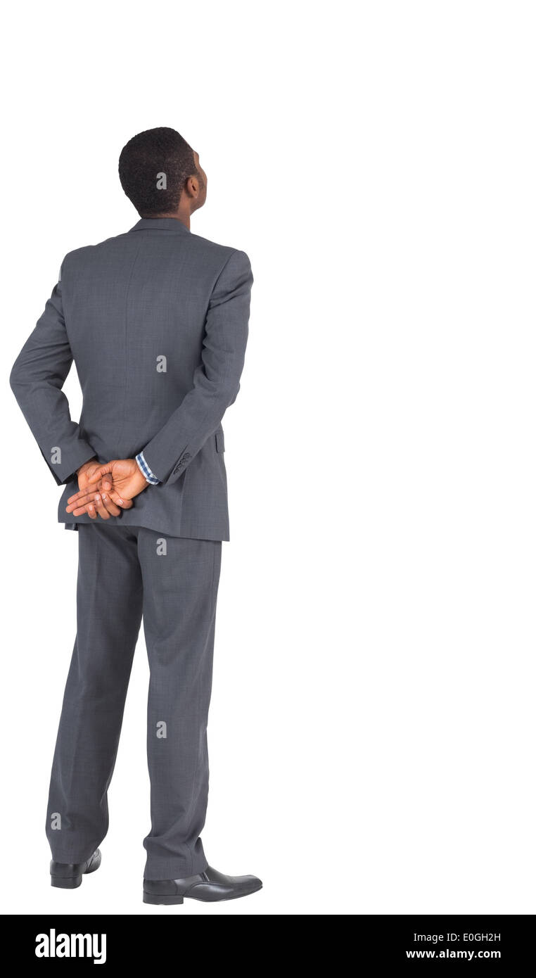 Businessman standing with hands behind back Stock Photo - Alamy