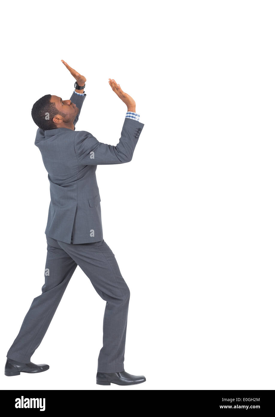 Businessman standing and pushing up Stock Photo - Alamy