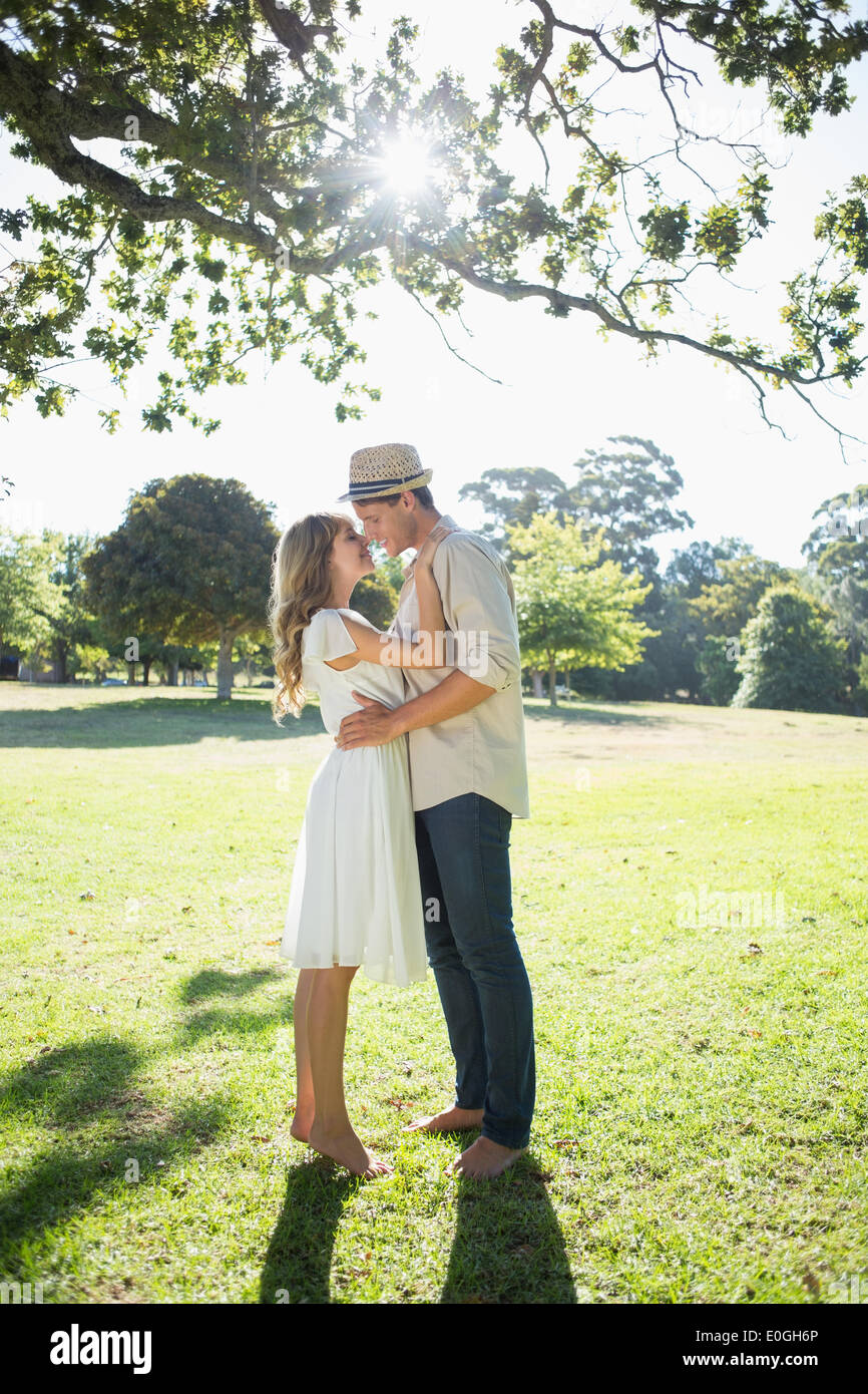 Happy young couple embracing kissing park summer hi-res stock ...