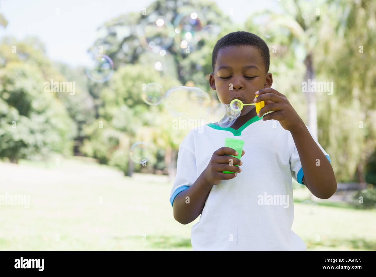 Little boy blowing bubbles in the park Stock Photo - Alamy