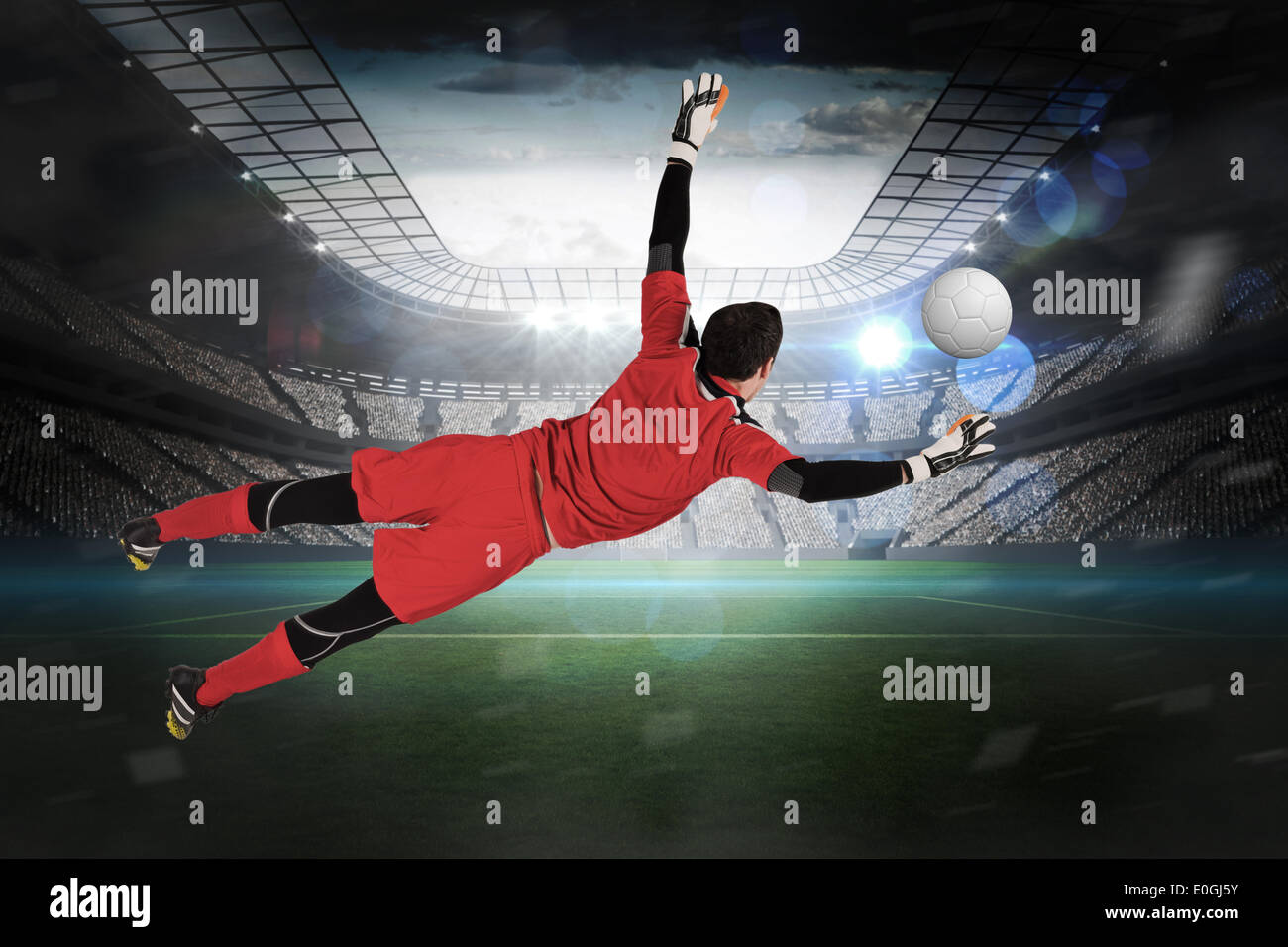 Fit goal keeper jumping up Stock Photo - Alamy