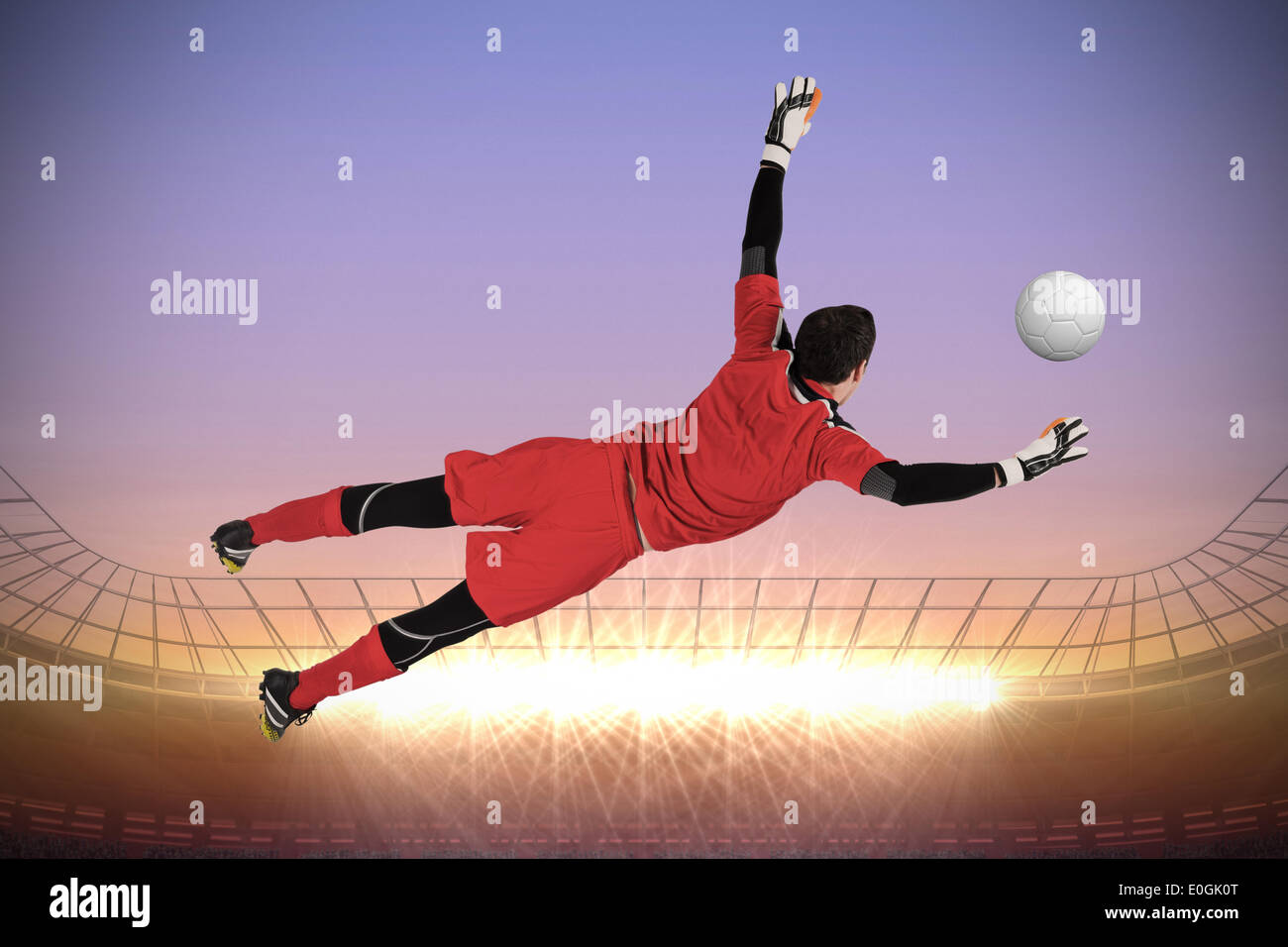 Fit goal keeper jumping up Stock Photo - Alamy