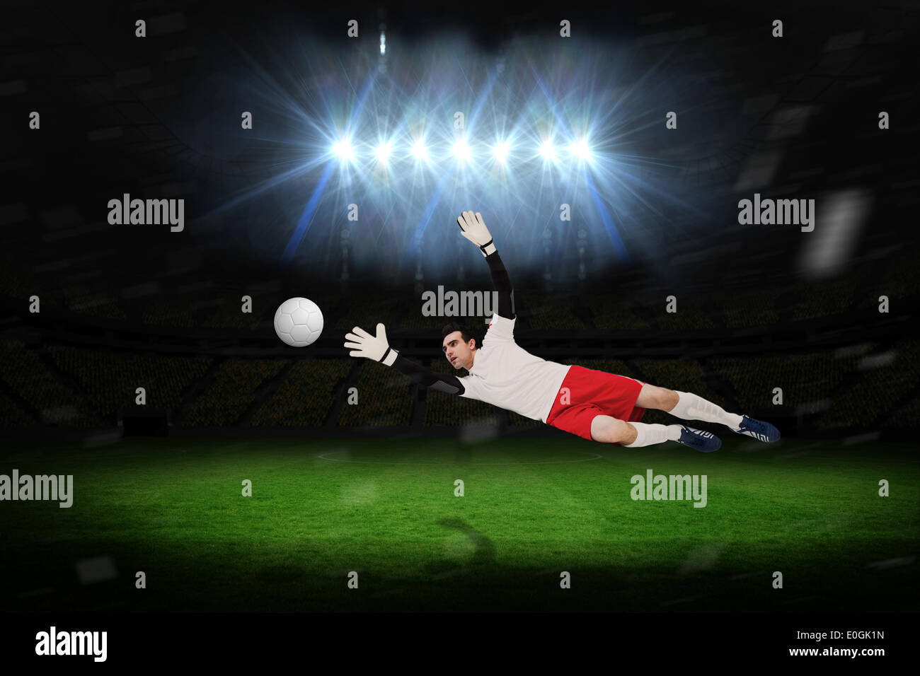 Goalkeeper in white making a save Stock Photo - Alamy
