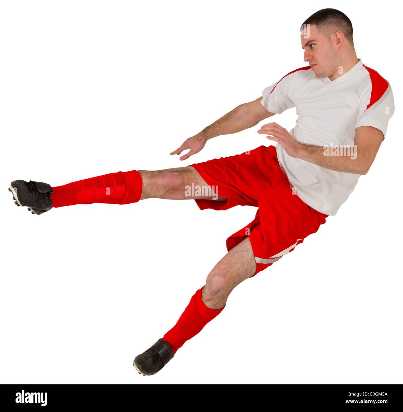 Fit football player playing and kicking Stock Photo - Alamy