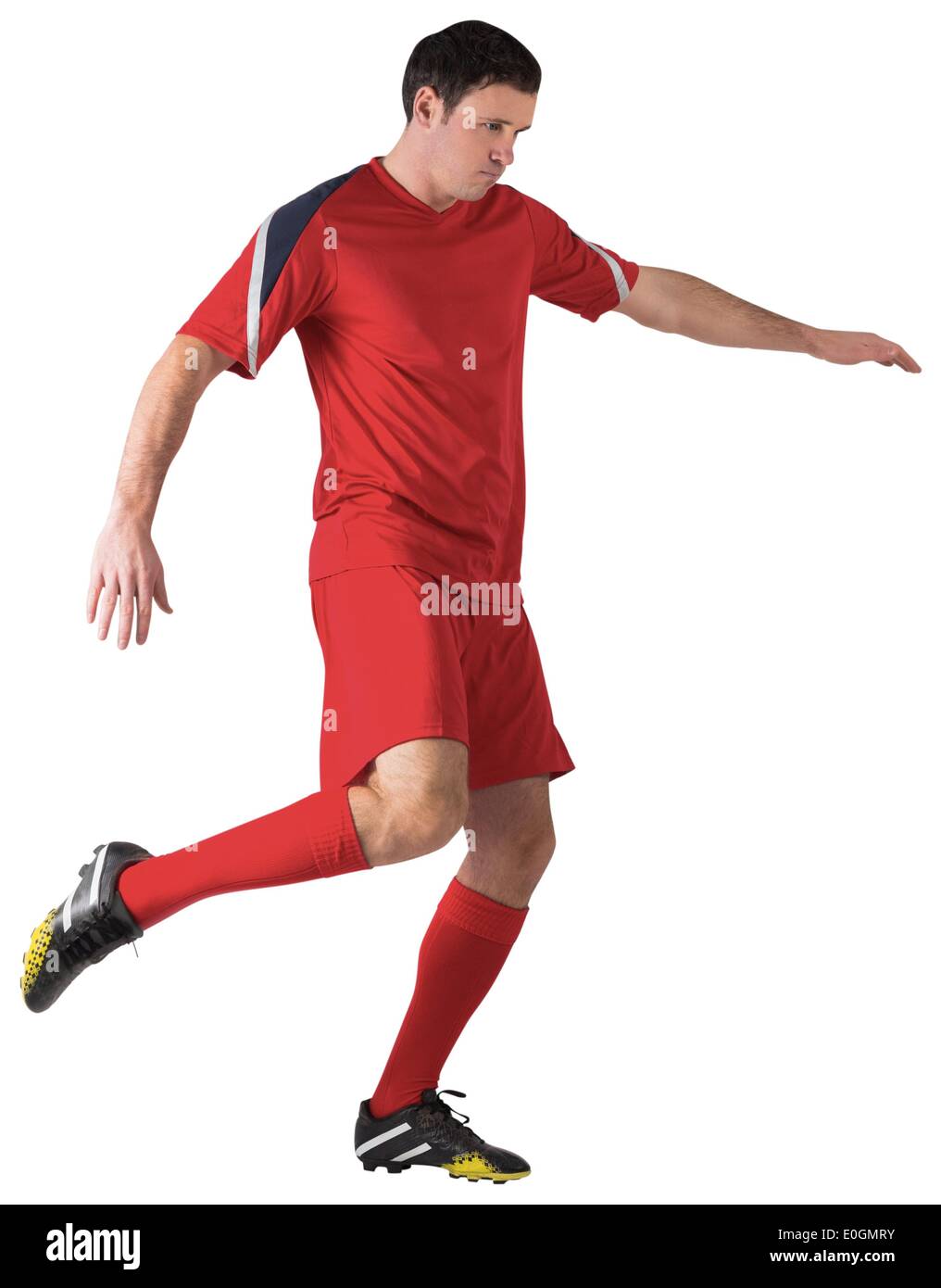 Football player in red kicking Stock Photo - Alamy