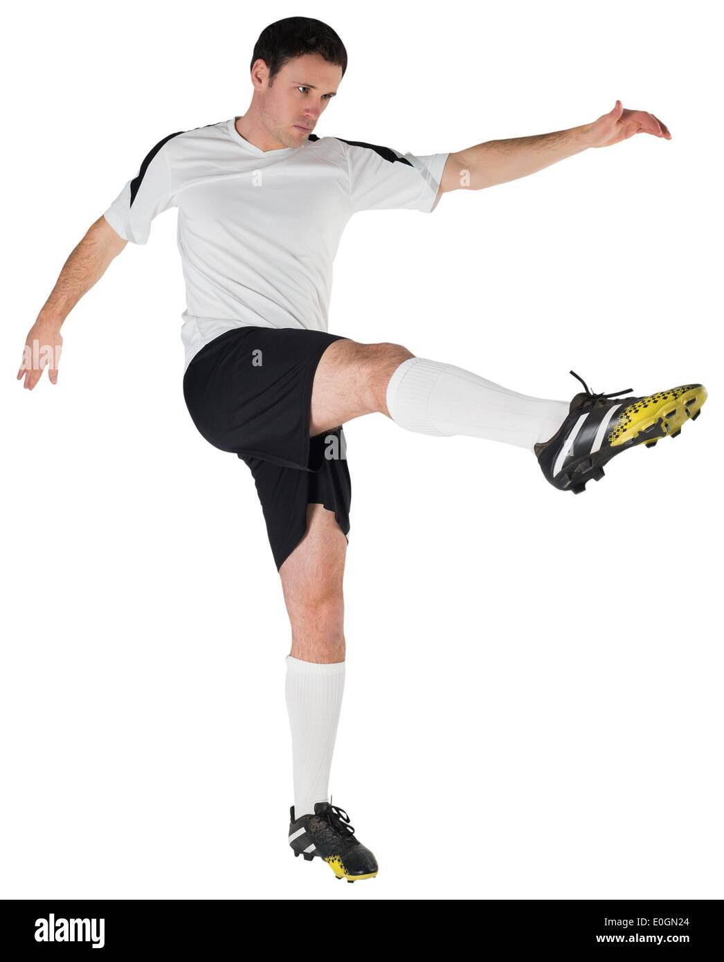 Football player in white kicking Stock Photo - Alamy