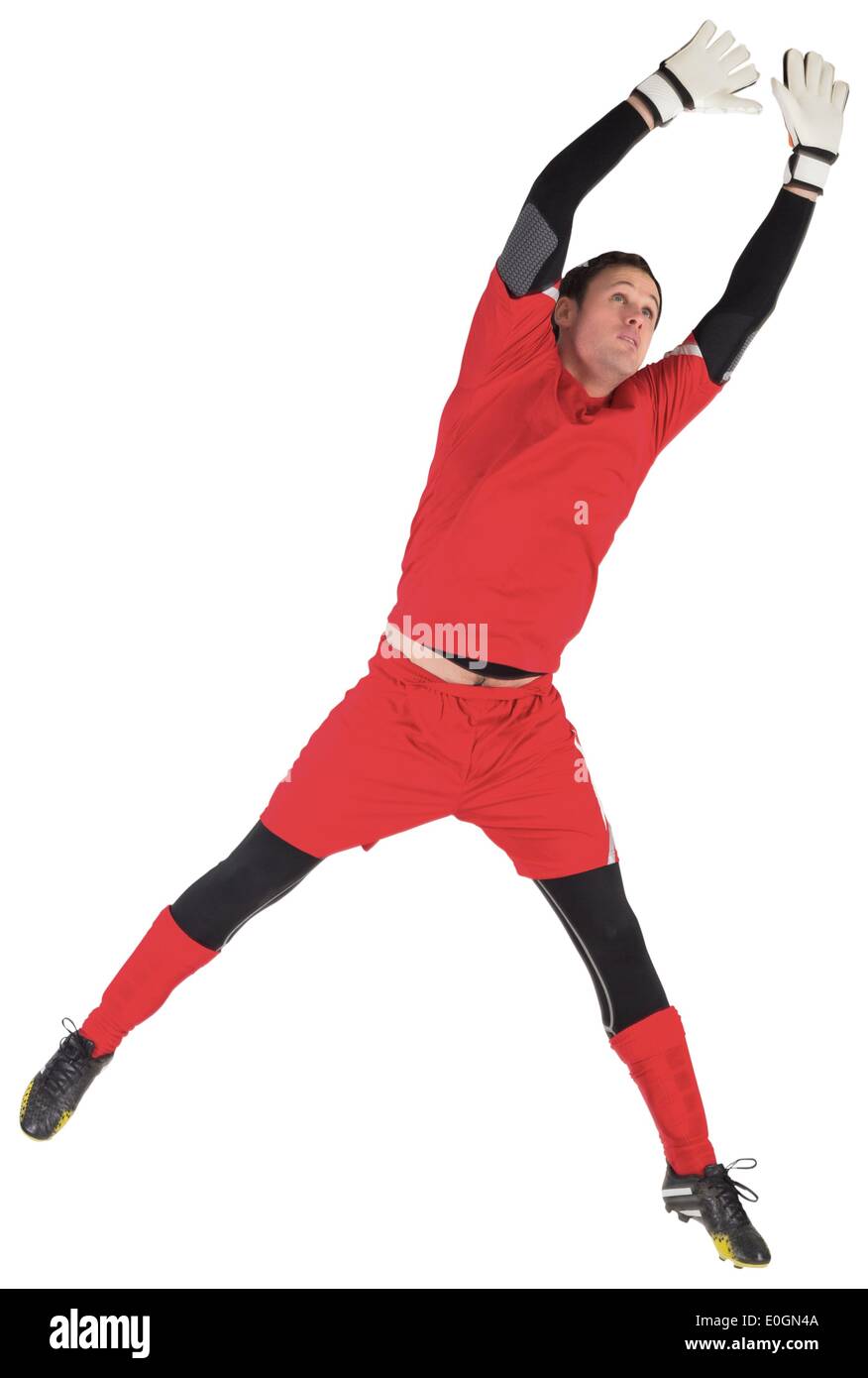 Fit goal keeper jumping up against black background with spark Stock ...
