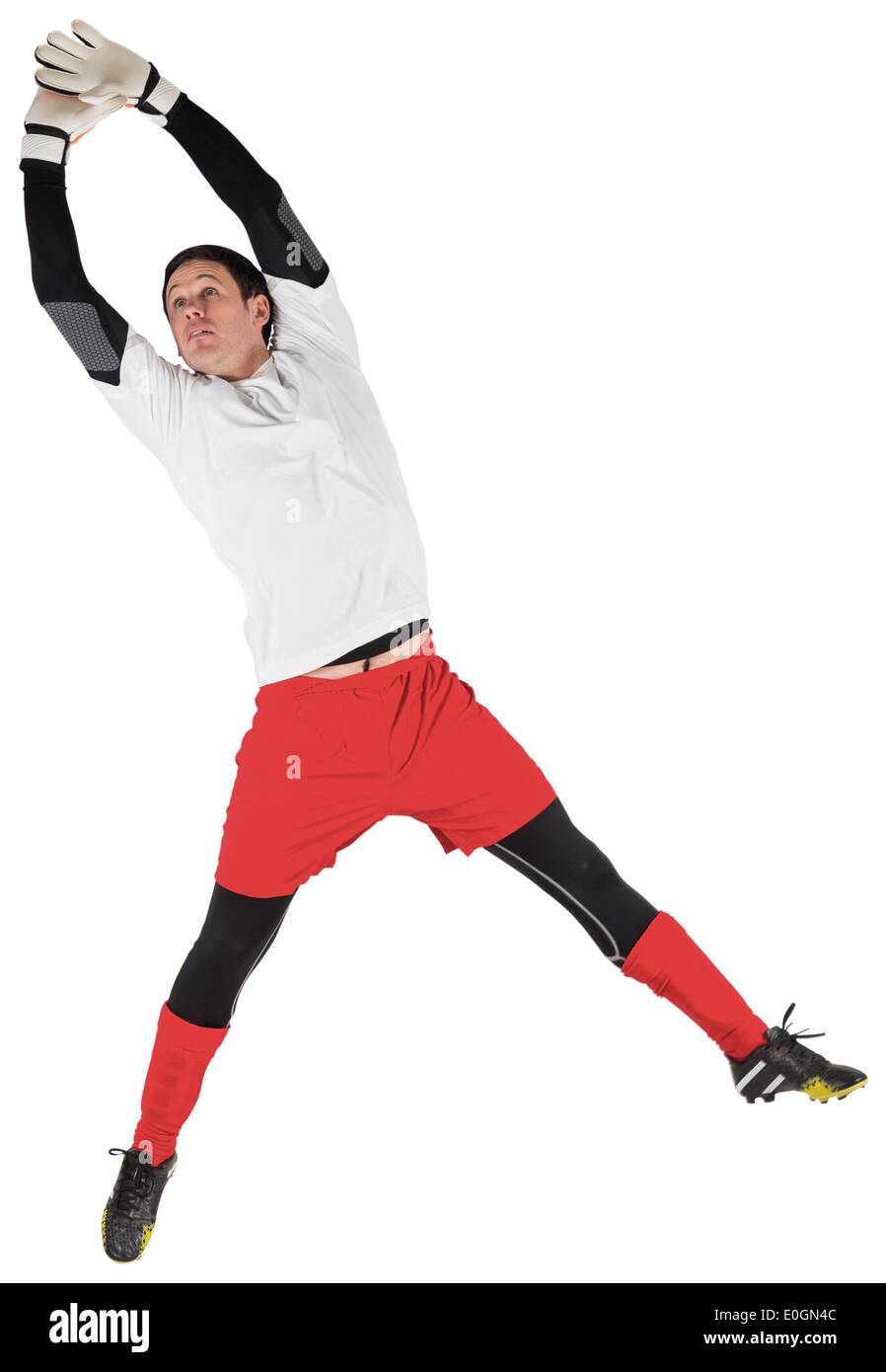 Fit goal keeper jumping up Stock Photo - Alamy