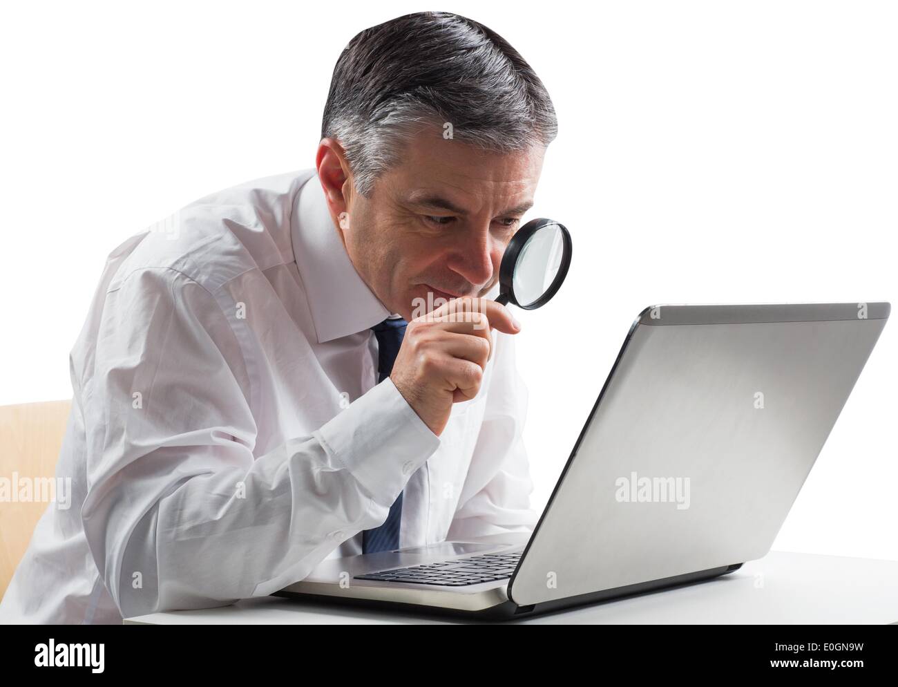 Mature businessman examining with magnifying glass Stock Photo - Alamy