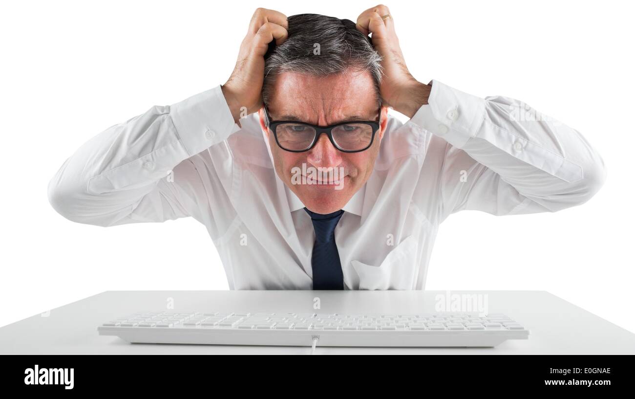 Stressed businessman using a keyboard Stock Photo - Alamy