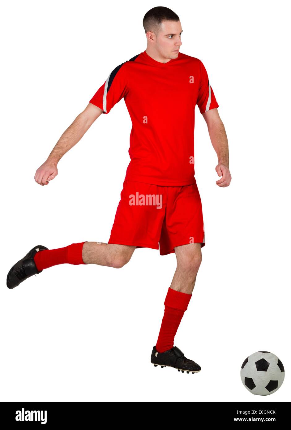 Fit football player playing with ball Stock Photo - Alamy