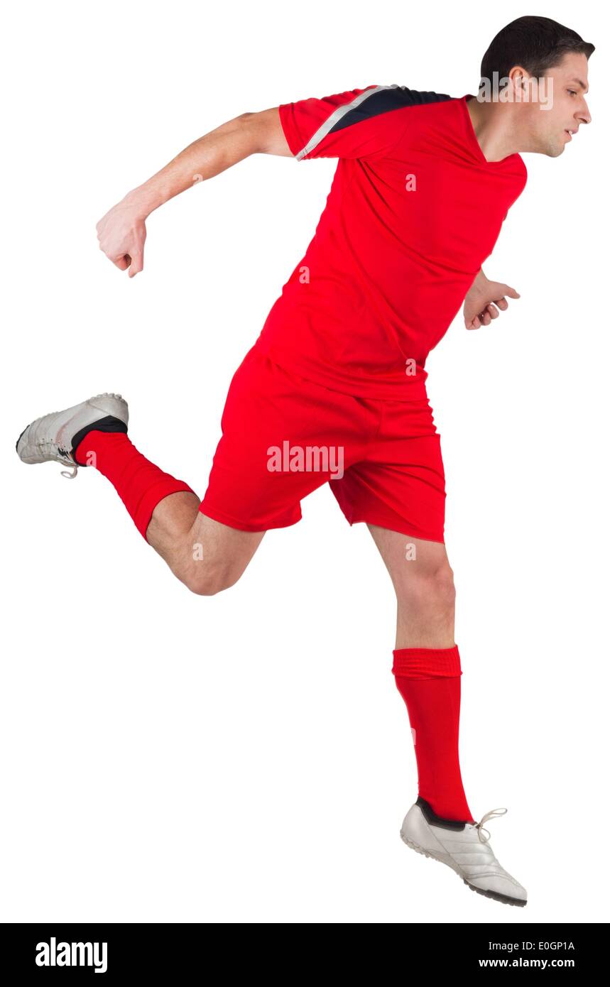 Fit football player jumping up Stock Photo - Alamy