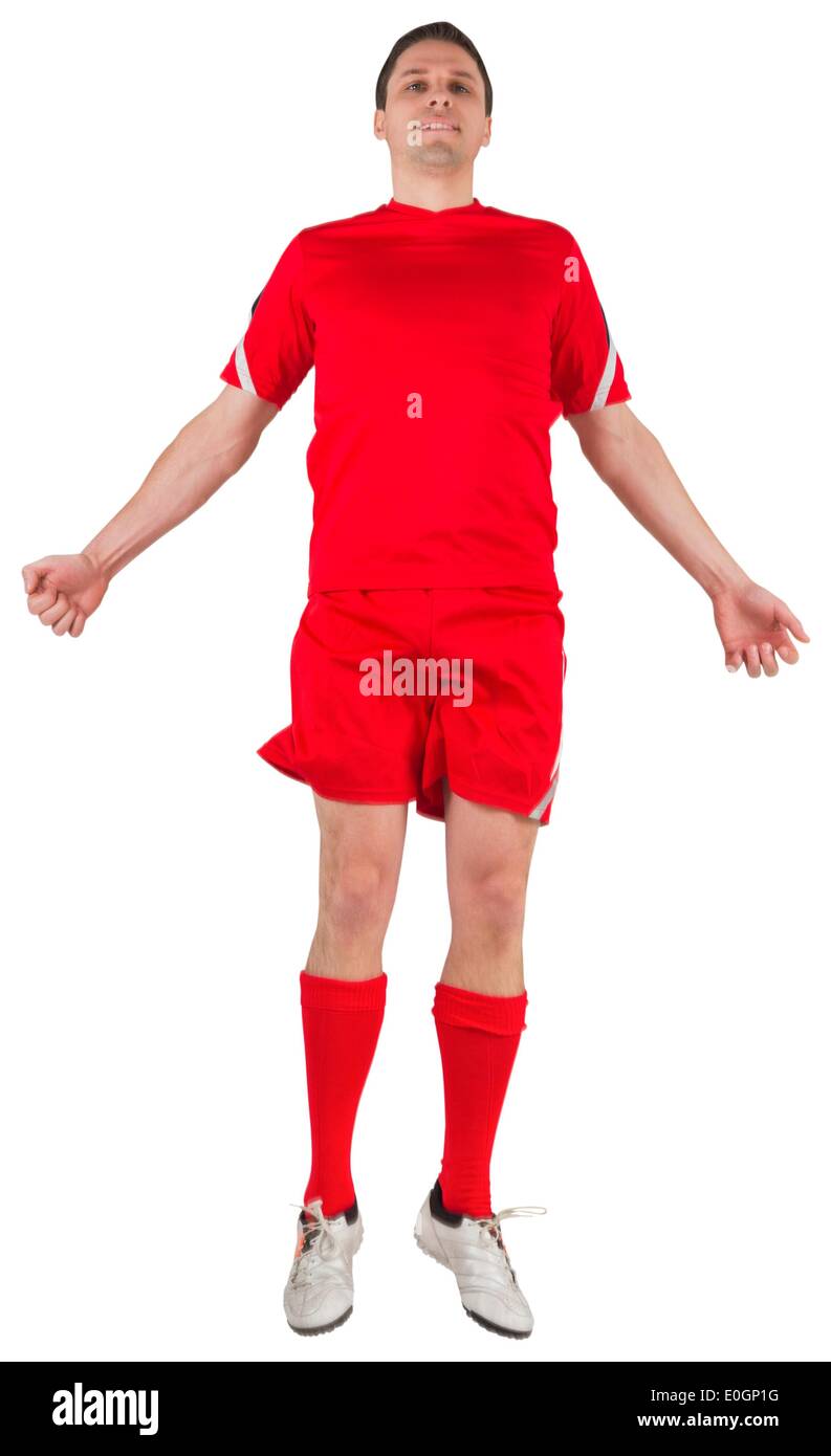 Fit football player jumping up Stock Photo - Alamy