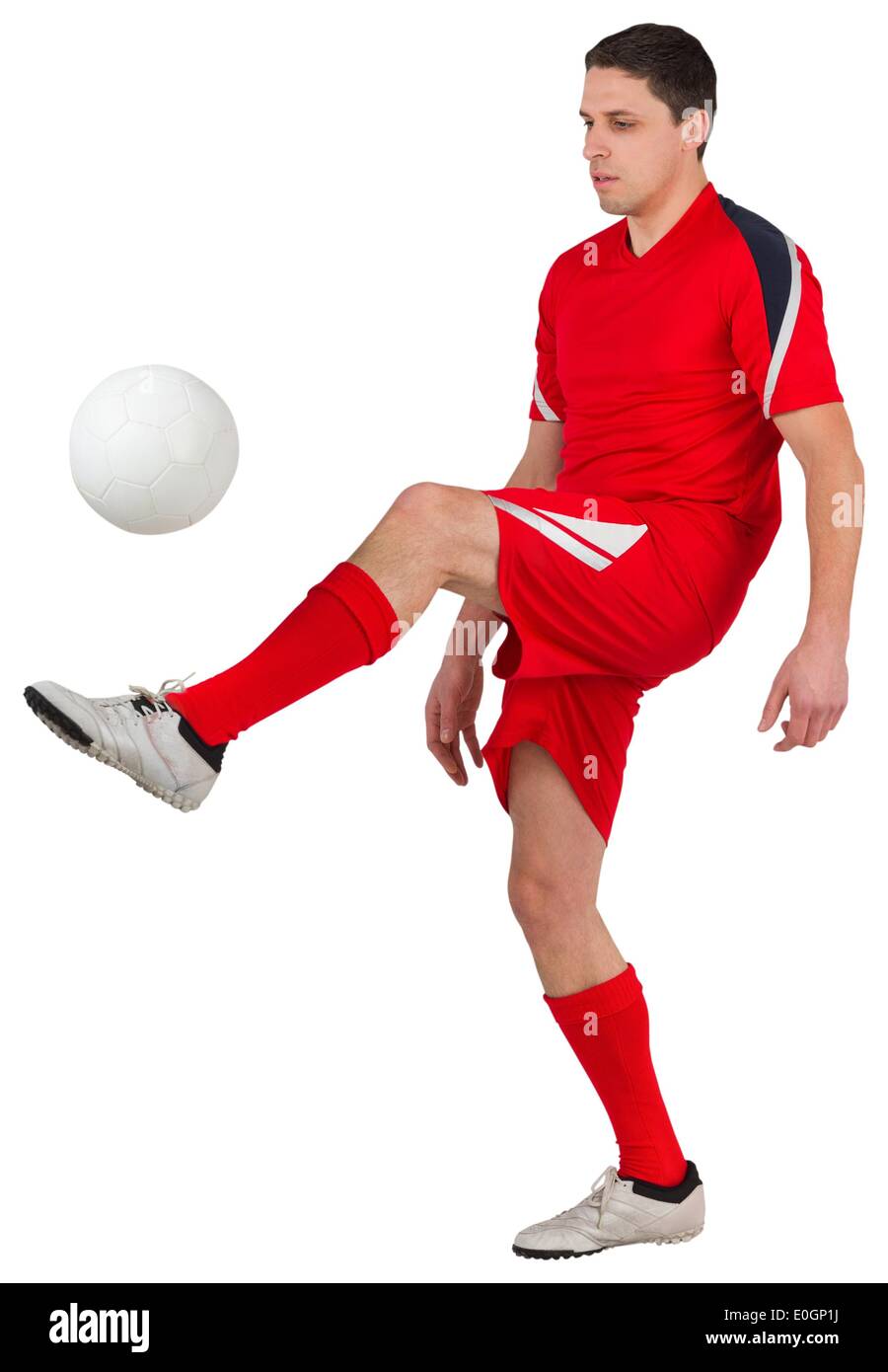 Fit young football player kicking Stock Photo - Alamy