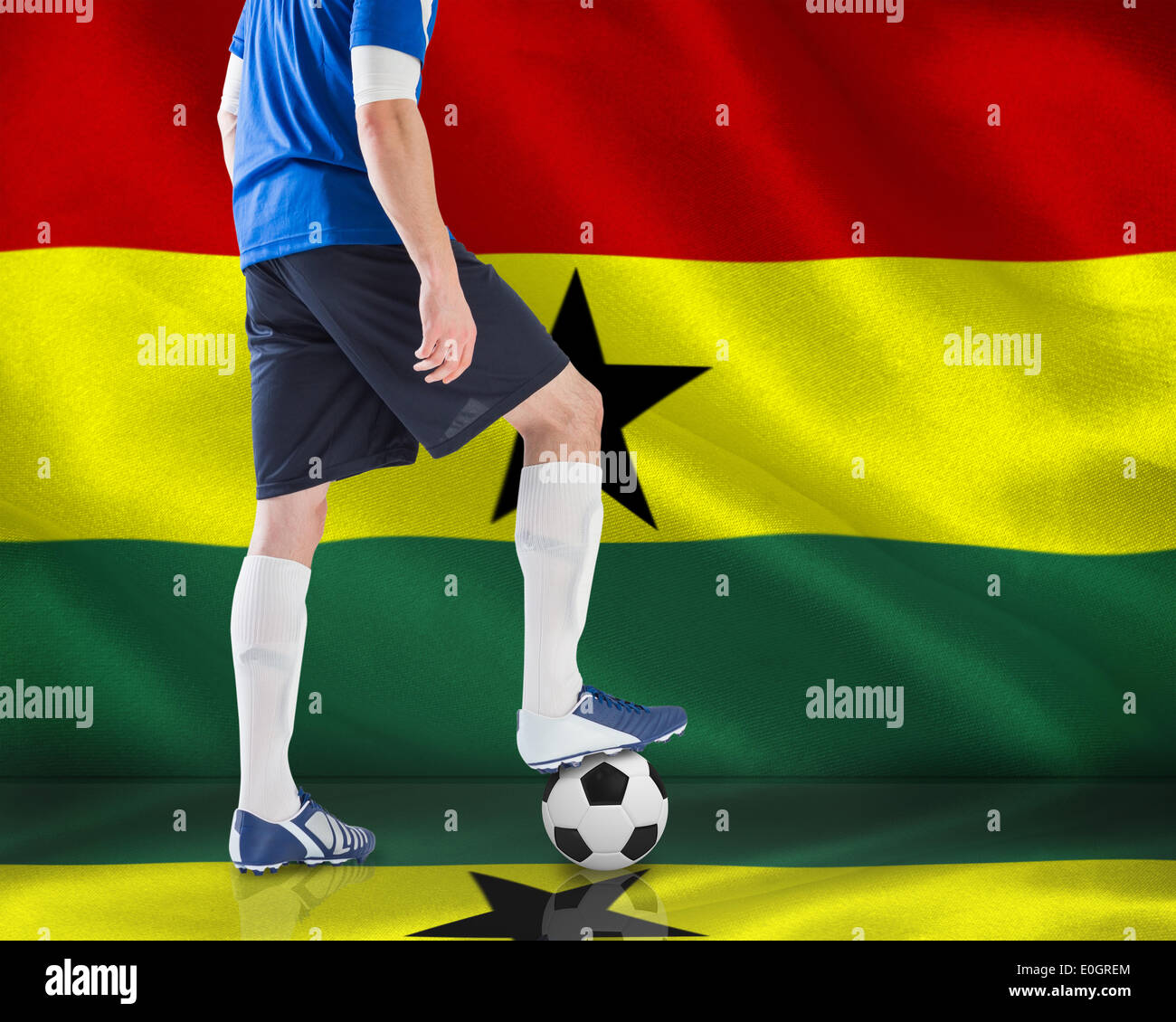 Football player standing with ball Stock Photo - Alamy