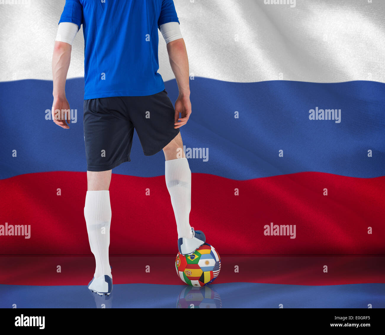 Football player standing with ball Stock Photo - Alamy