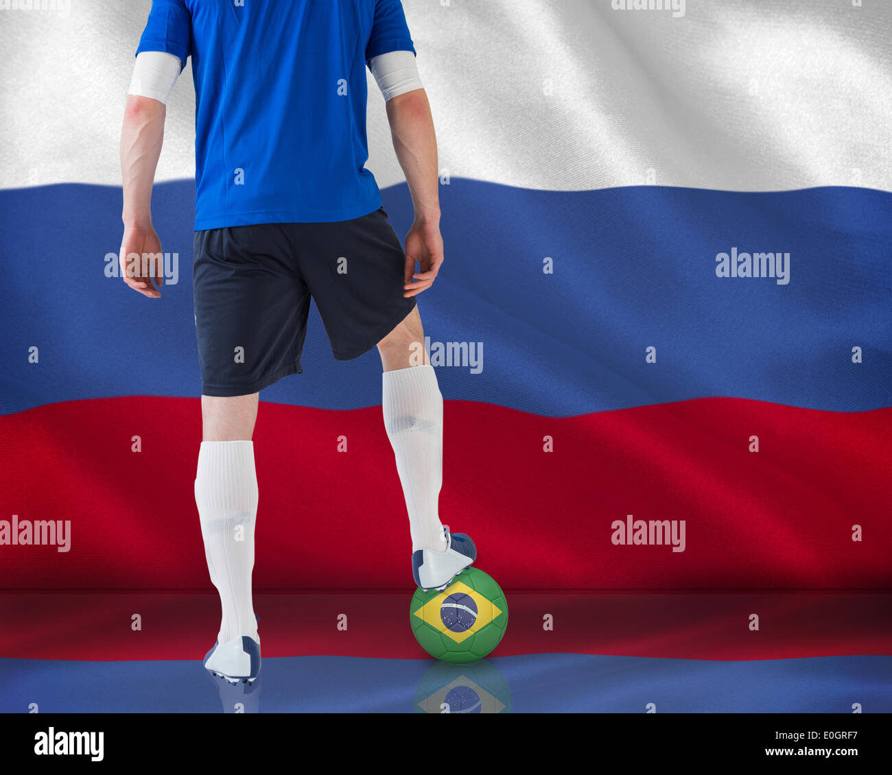 Football player standing with ball Stock Photo - Alamy