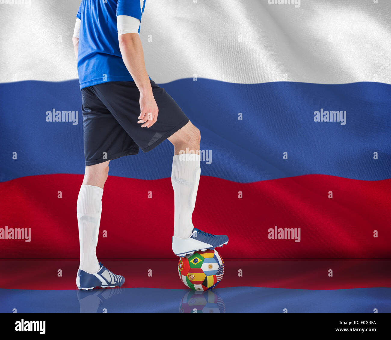 Football player standing with ball Stock Photo - Alamy