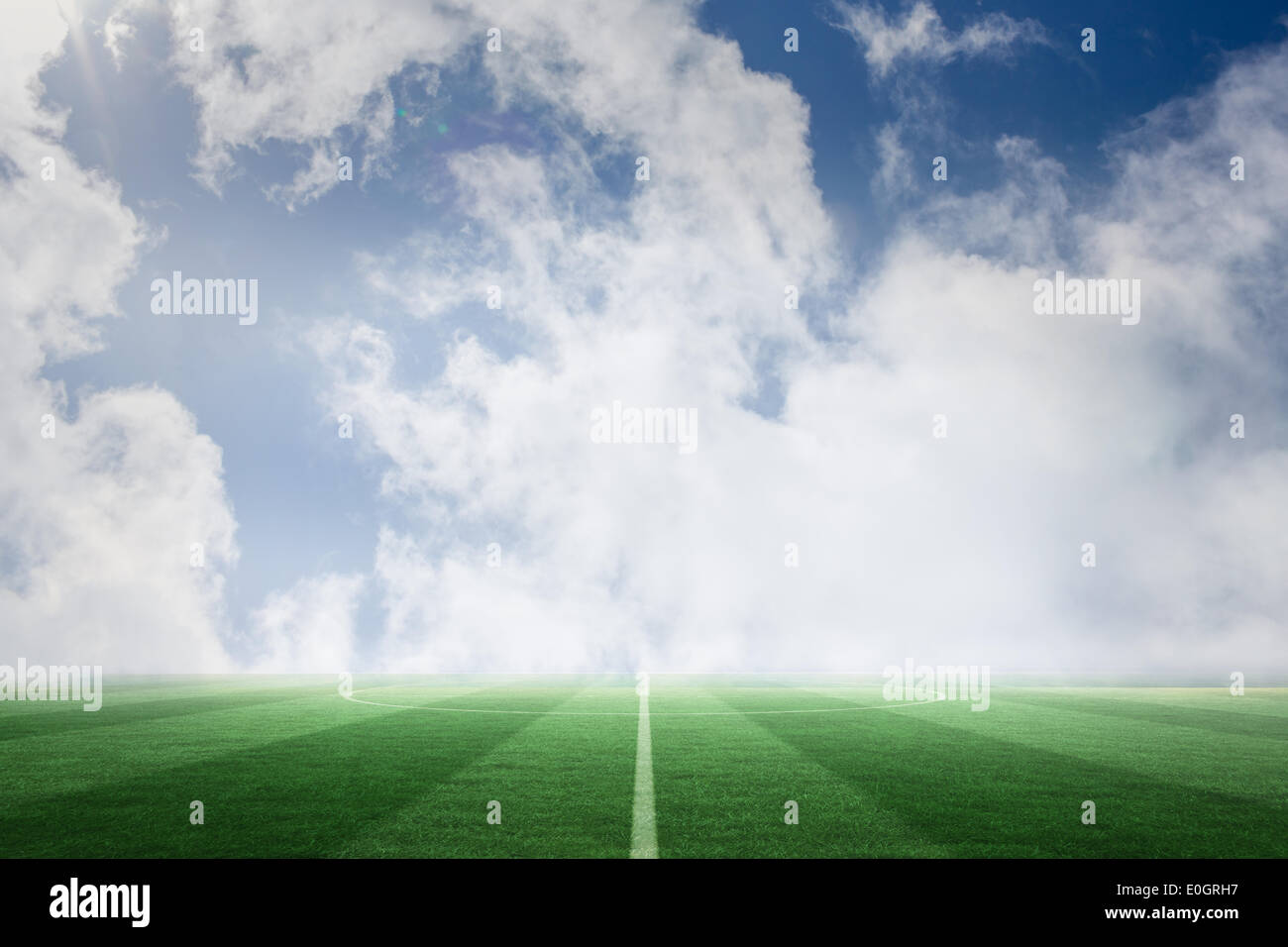 Football pitch under blue sky Stock Photo - Alamy