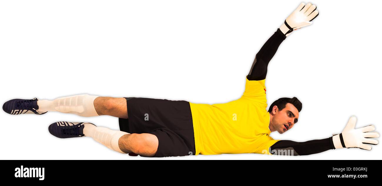 Goalkeeper in yellow making a save Stock Photo - Alamy