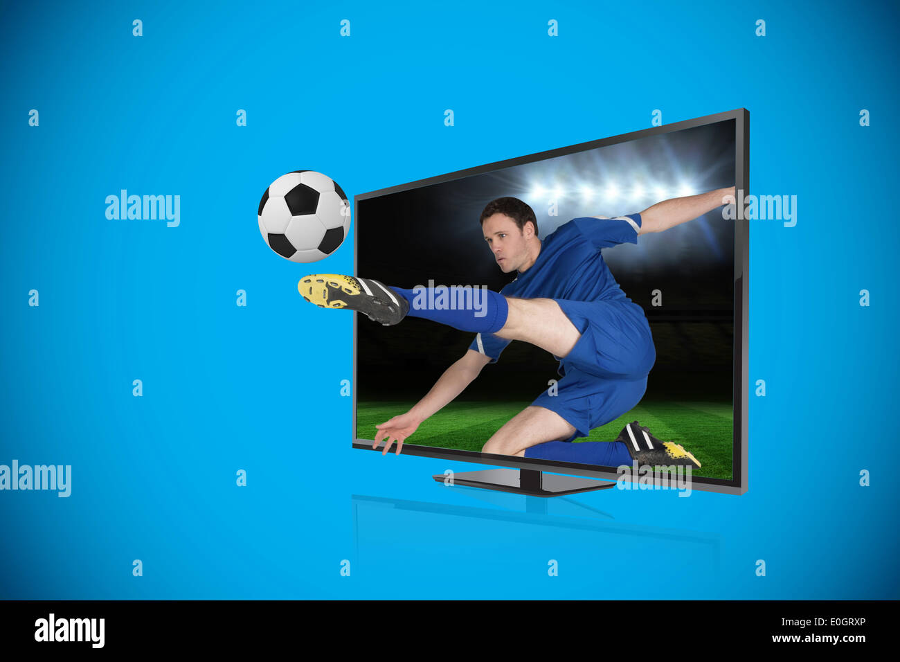Football player kicking ball through tv Stock Photo - Alamy