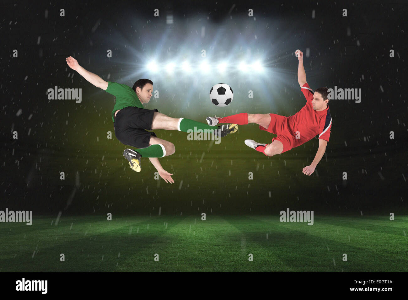 Football players tackling for the ball Stock Photo - Alamy