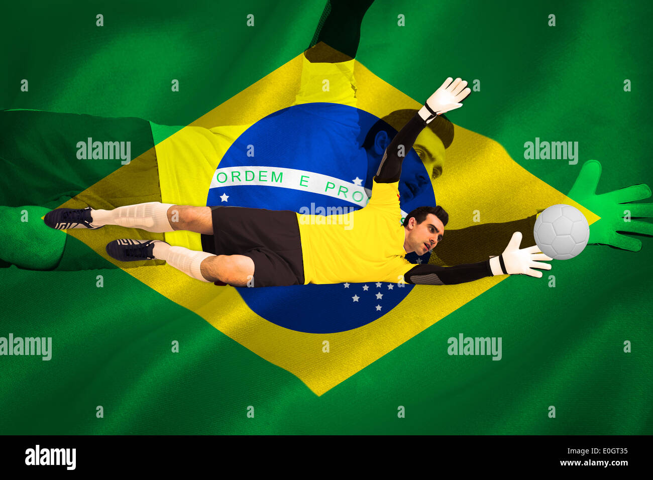 Goalkeeper in yellow making a save Stock Photo - Alamy