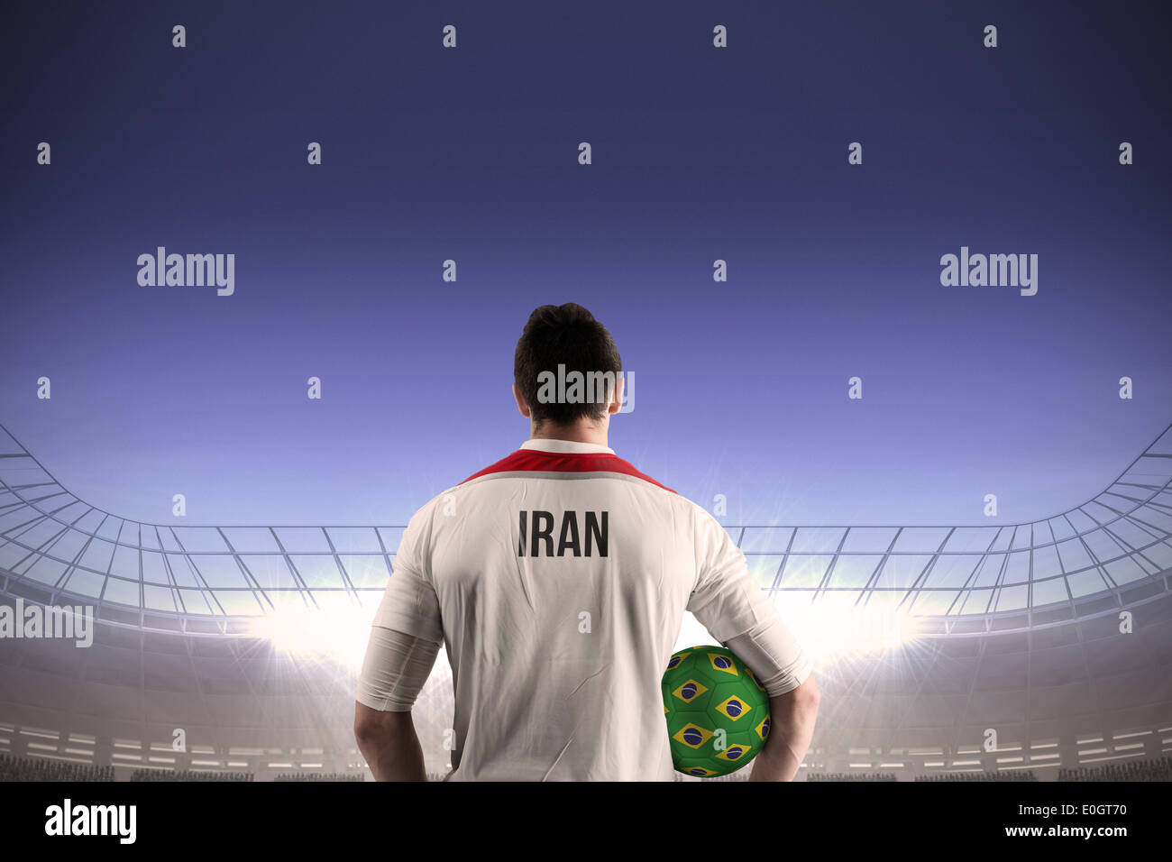 Iran football player holding ball Stock Photo - Alamy