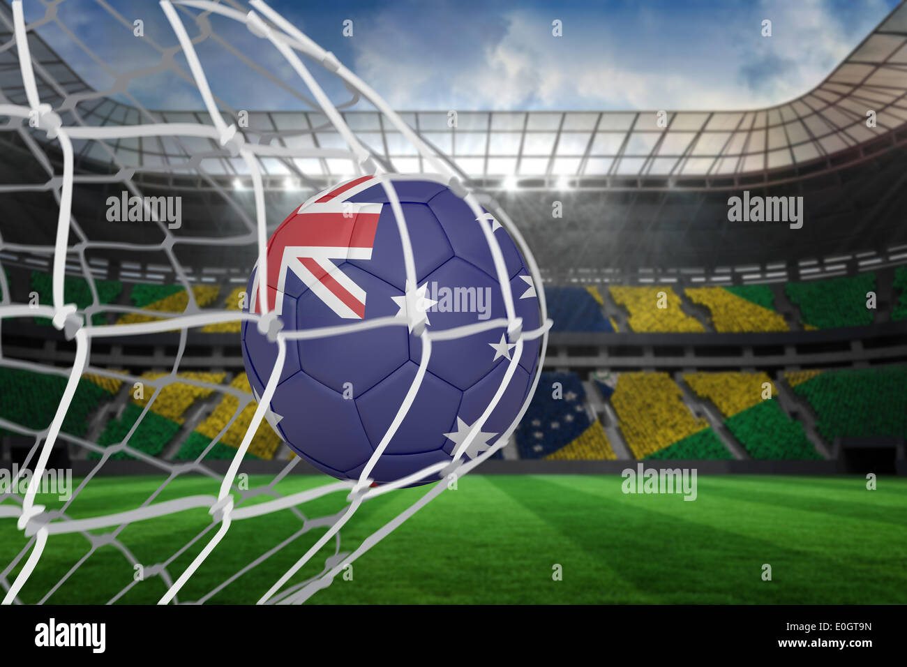 Football in australia colours at back of net Stock Photo - Alamy