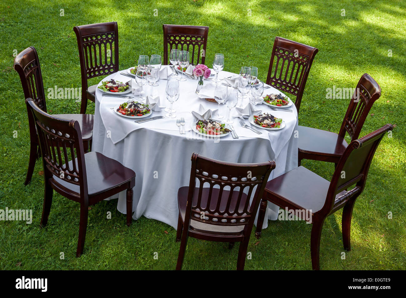 Table setting with chairs for garden banquet Stock Photo - Alamy