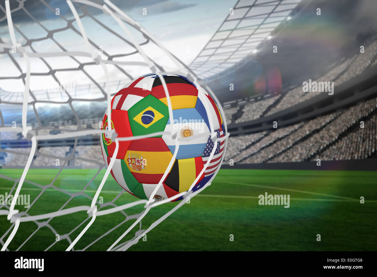 Football in multi national colours at back of net Stock Photo - Alamy