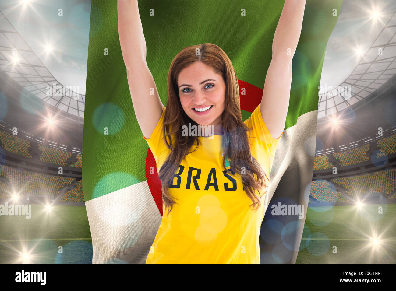 Pretty football fan in brasil t-shirt holding algeria flag Stock Photo ...