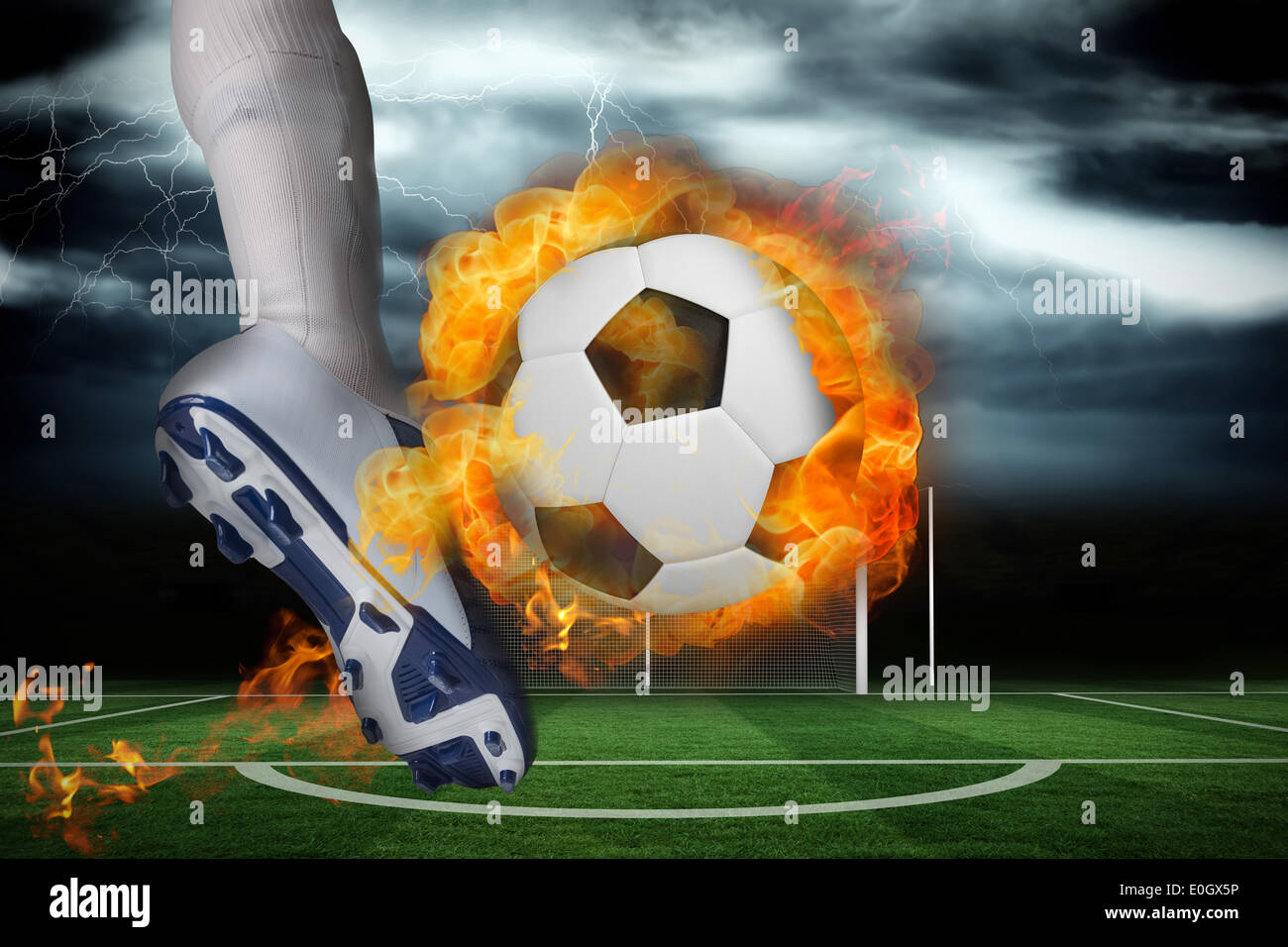 Football player kicking flaming ball Stock Photo - Alamy