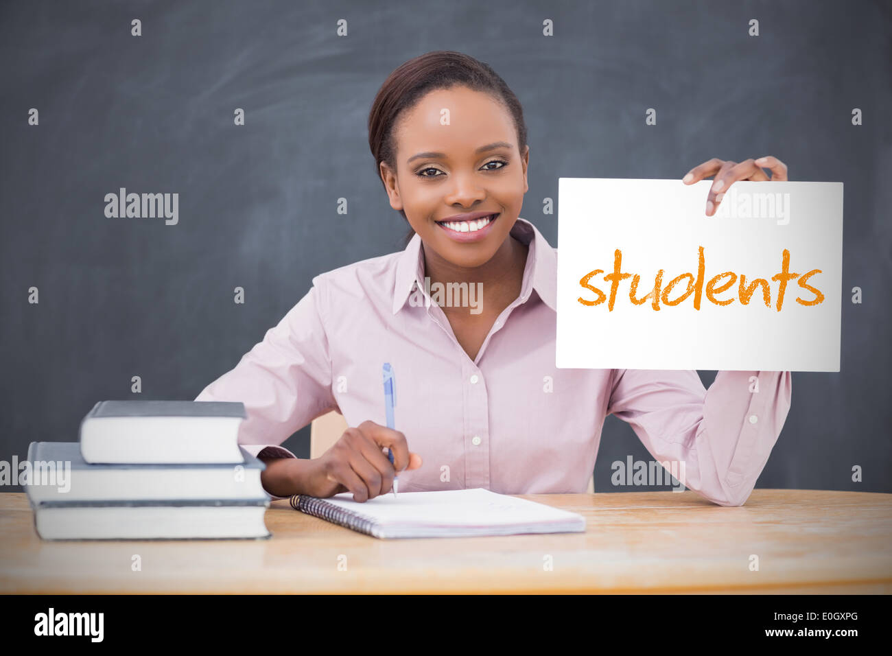 Happy teacher holding page showing students Stock Photo - Alamy